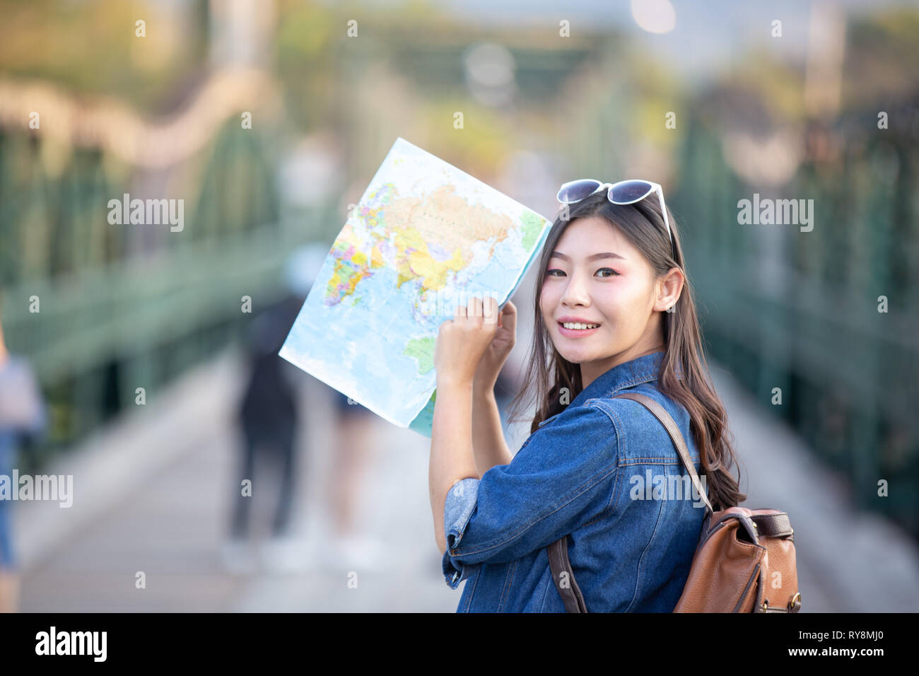 Female tourists on hand have a happy travel map Stock Photo - Alamy