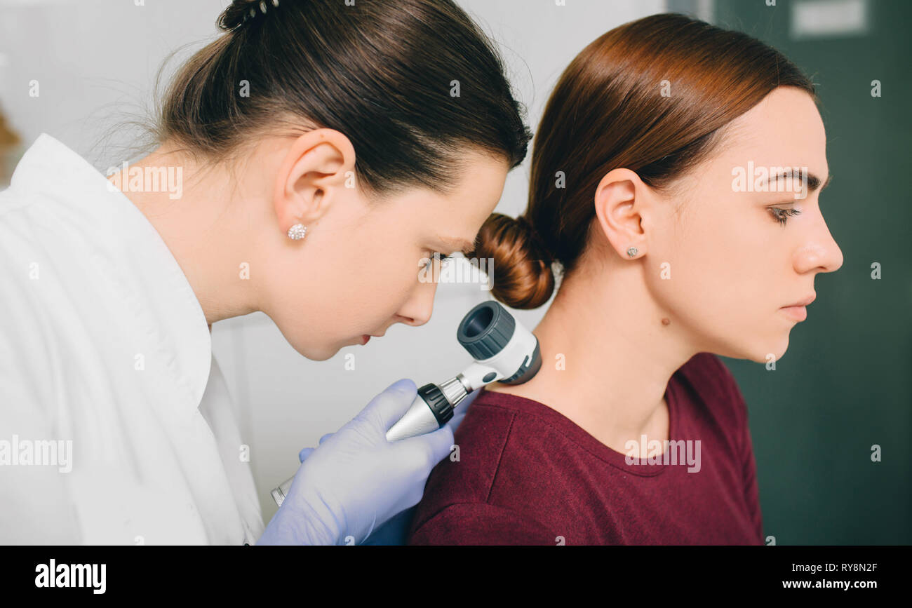 dermatologist exam skin mole on female neck using dermatoscope Stock ...
