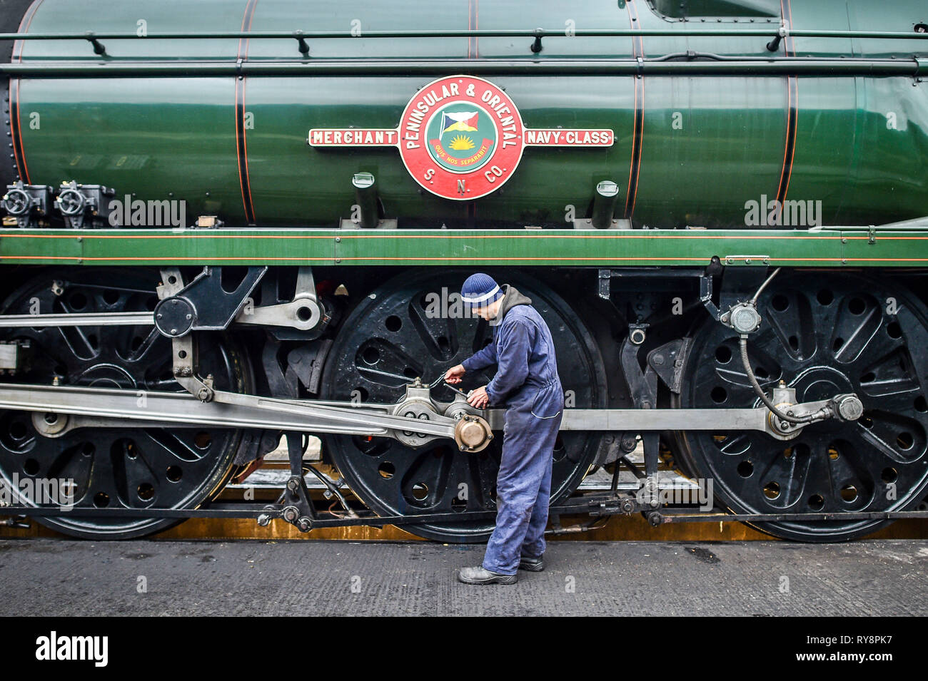 Engine driver Ben Evason pours lubricating oil into the big end part of ...