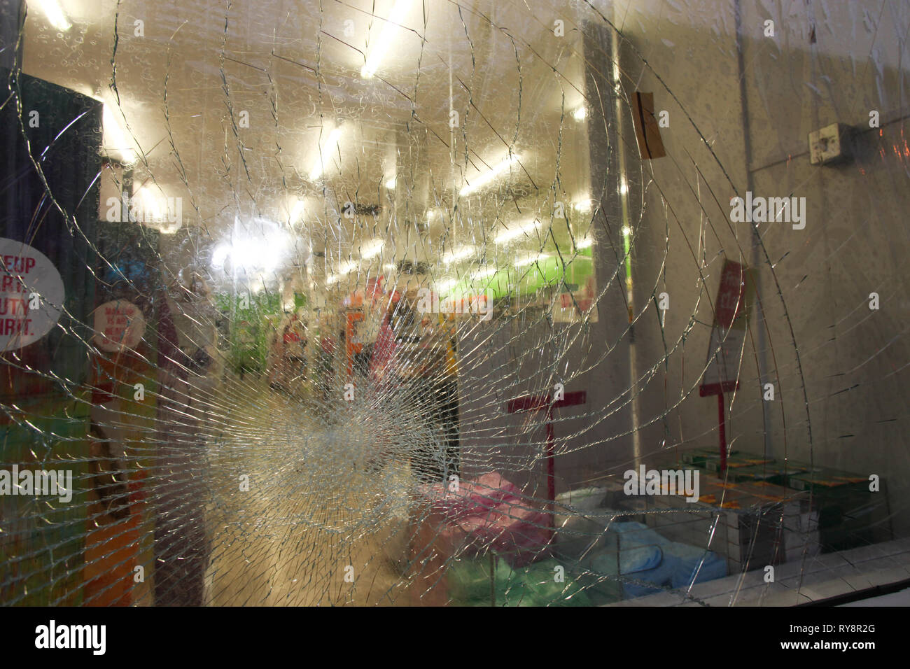 Smashed window to High street shop by vandals , trhreat of Lawlessness ...