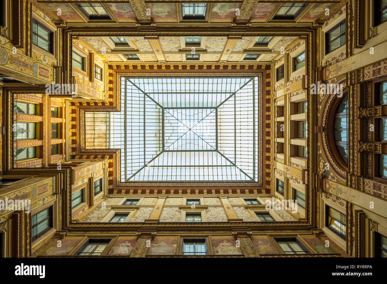 Looking up view of symmetrical covered glass skylight open air ...