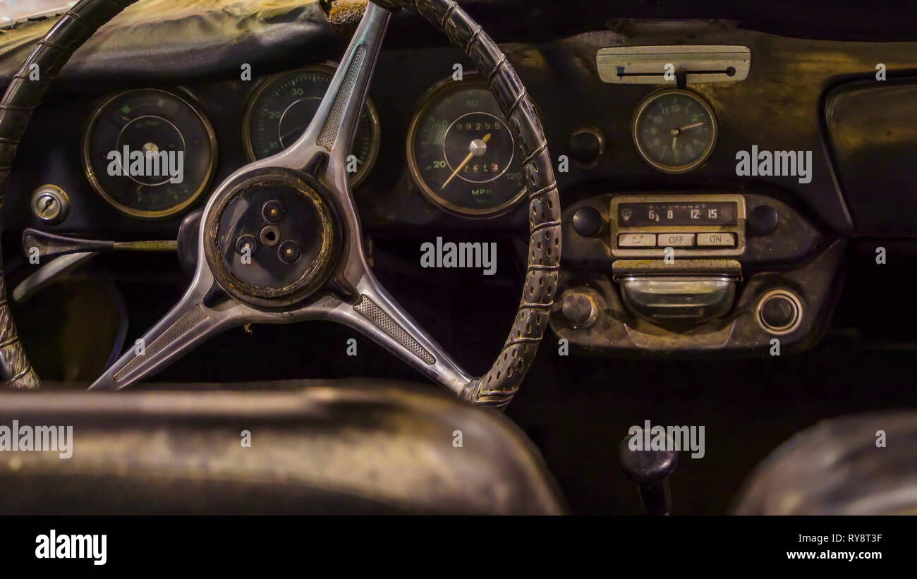The closer look of the vintage cars dashboard and the old cassete radio ...