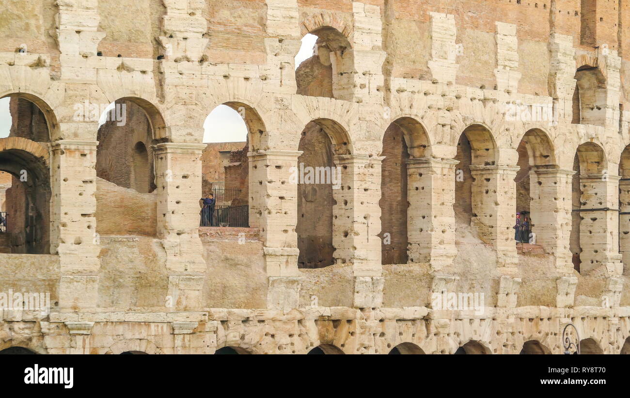The windows of the big Colosseum in Rome and the view outside with lots ...