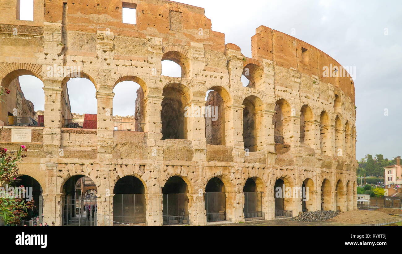 View outside the huge Colosseum with some holes on the ruined walls of ...