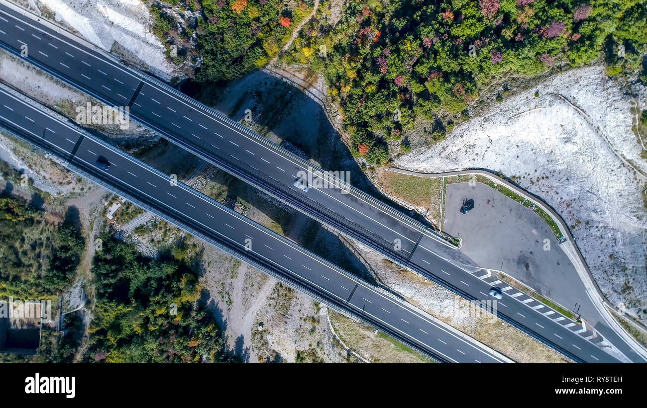 Cars passing by the bridge road in the mountain ranges called the ...