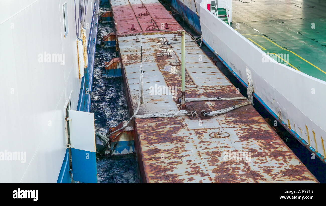 The metal pathway floating on the water in the port where the ferry ...