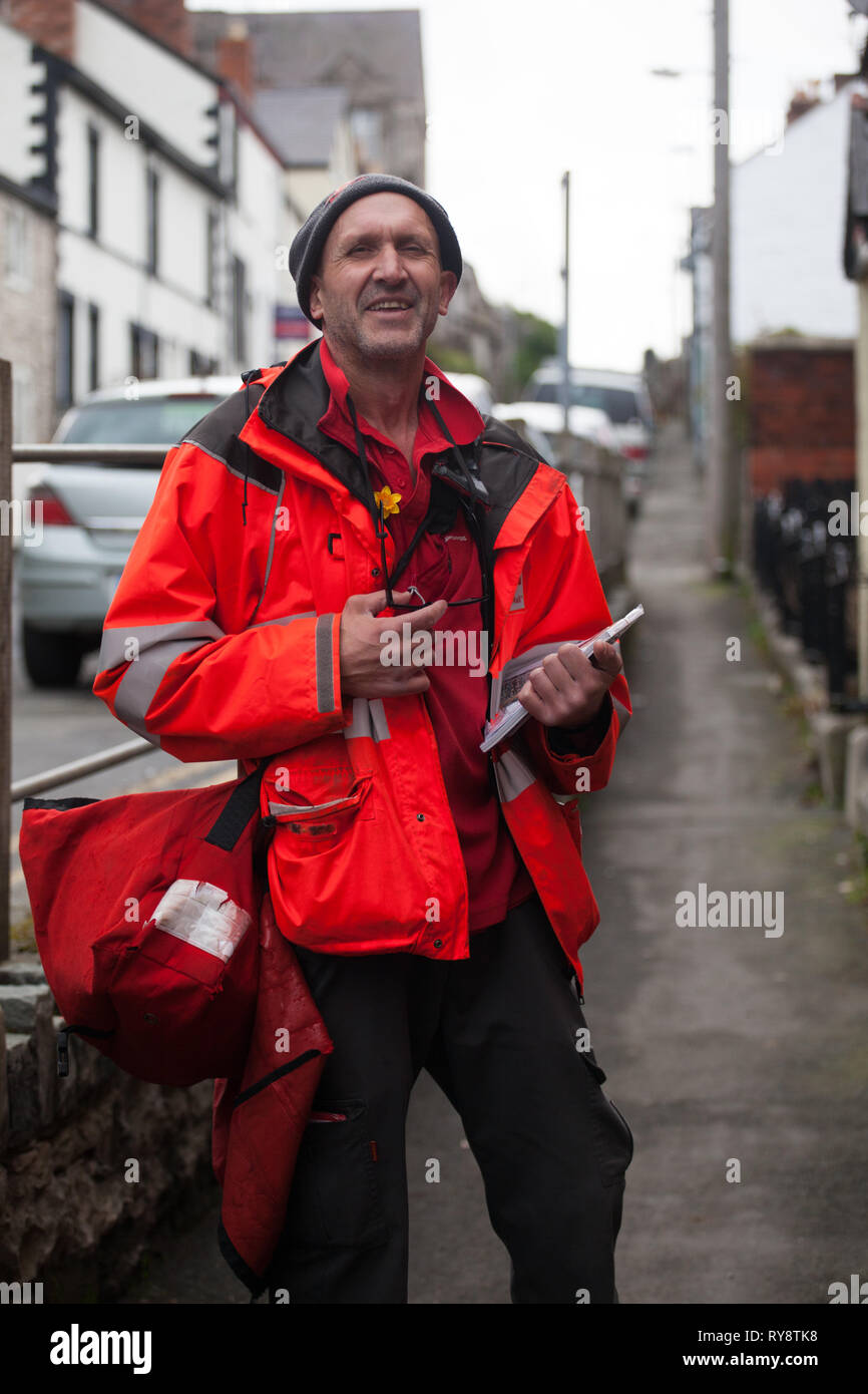 Friendly Post man delivering letters in small town in Wales Stock Photo ...