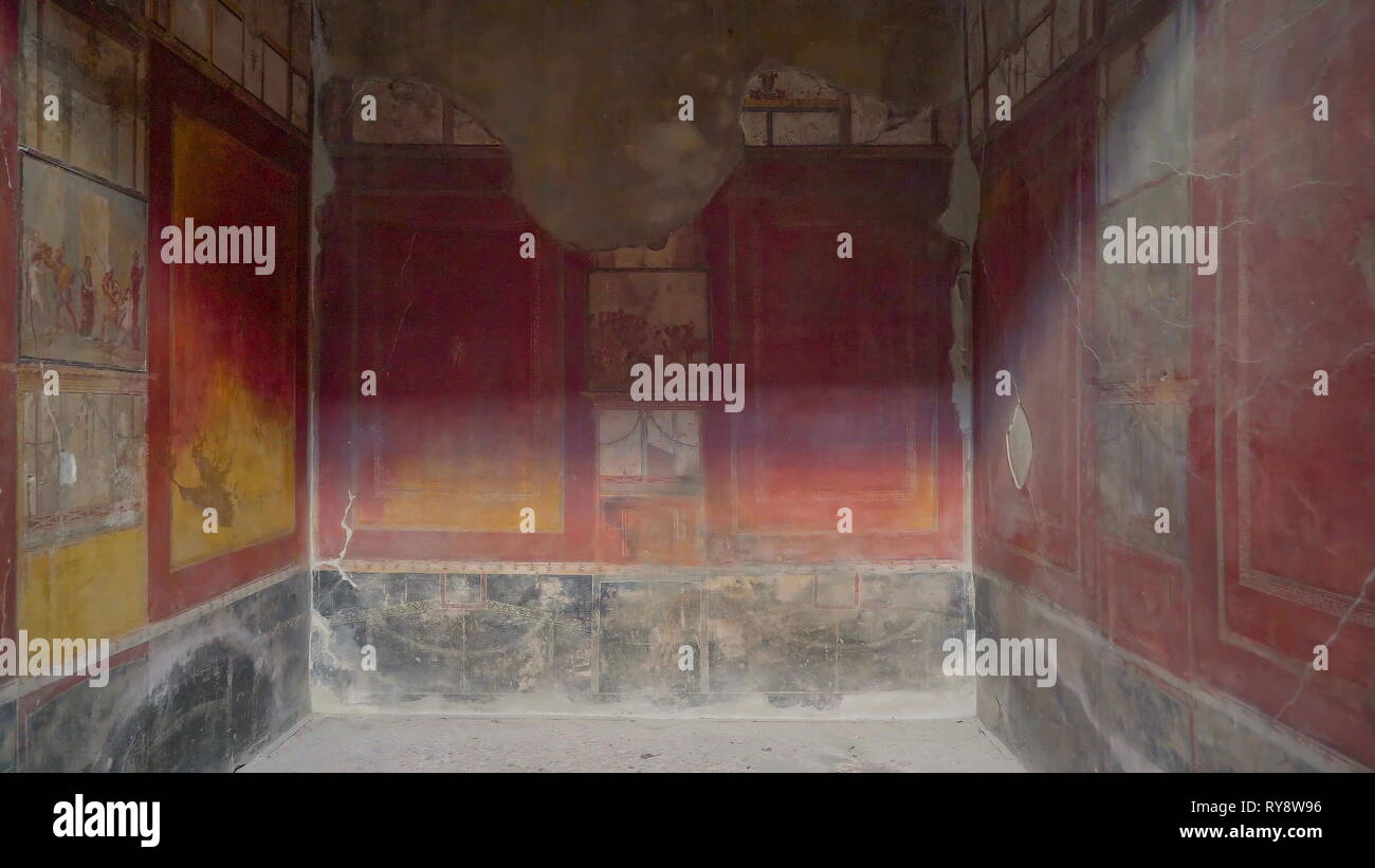 A dusty wall with red paint in Pompeii Italy inside the four corners of ...