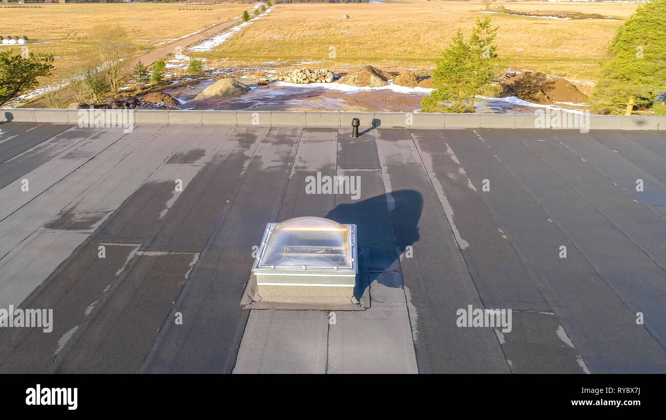 The convex shape window on the tin roof of the building with the ray of ...