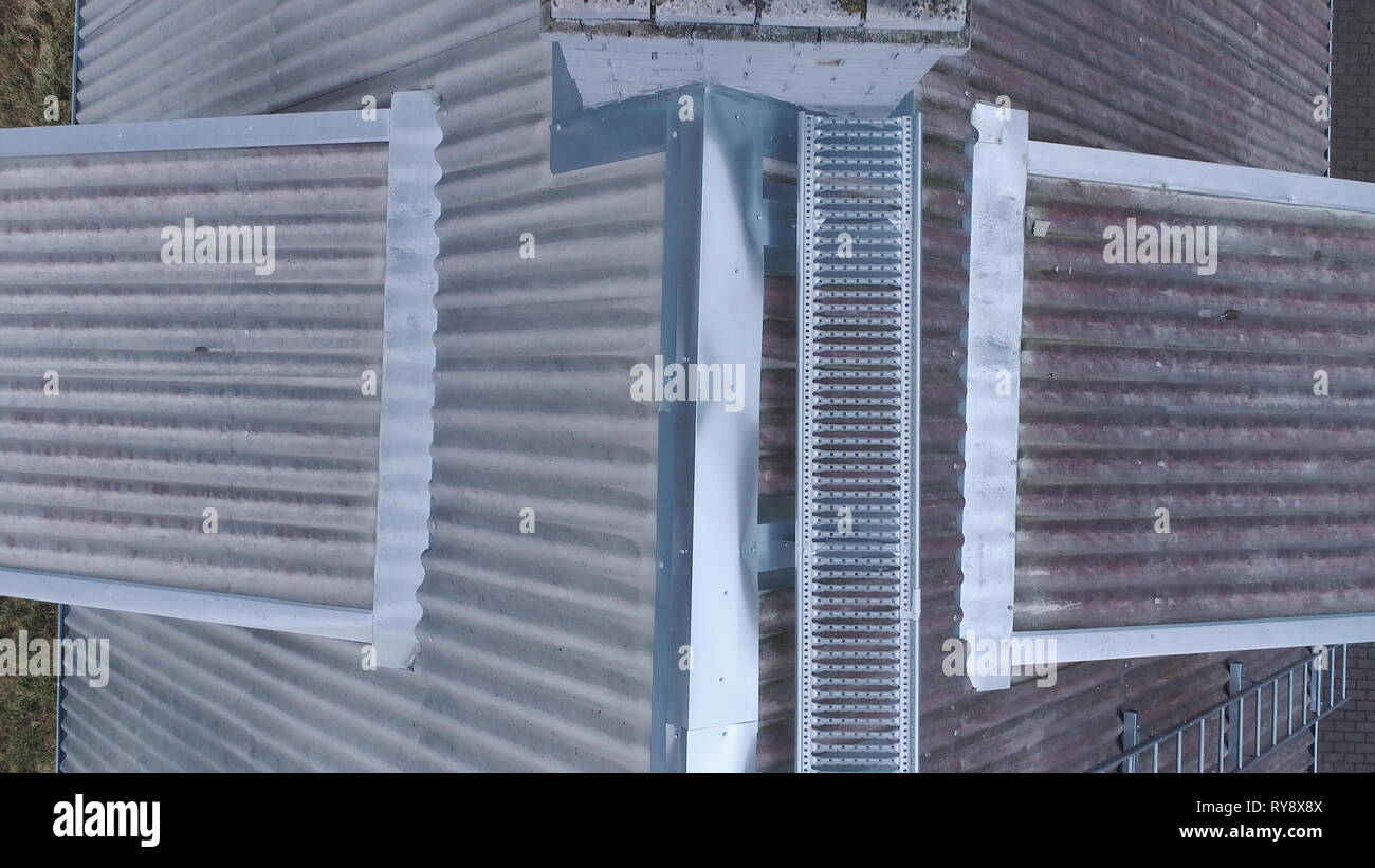 The chimney of the house with the tin roofs and the tin pipes on the ...