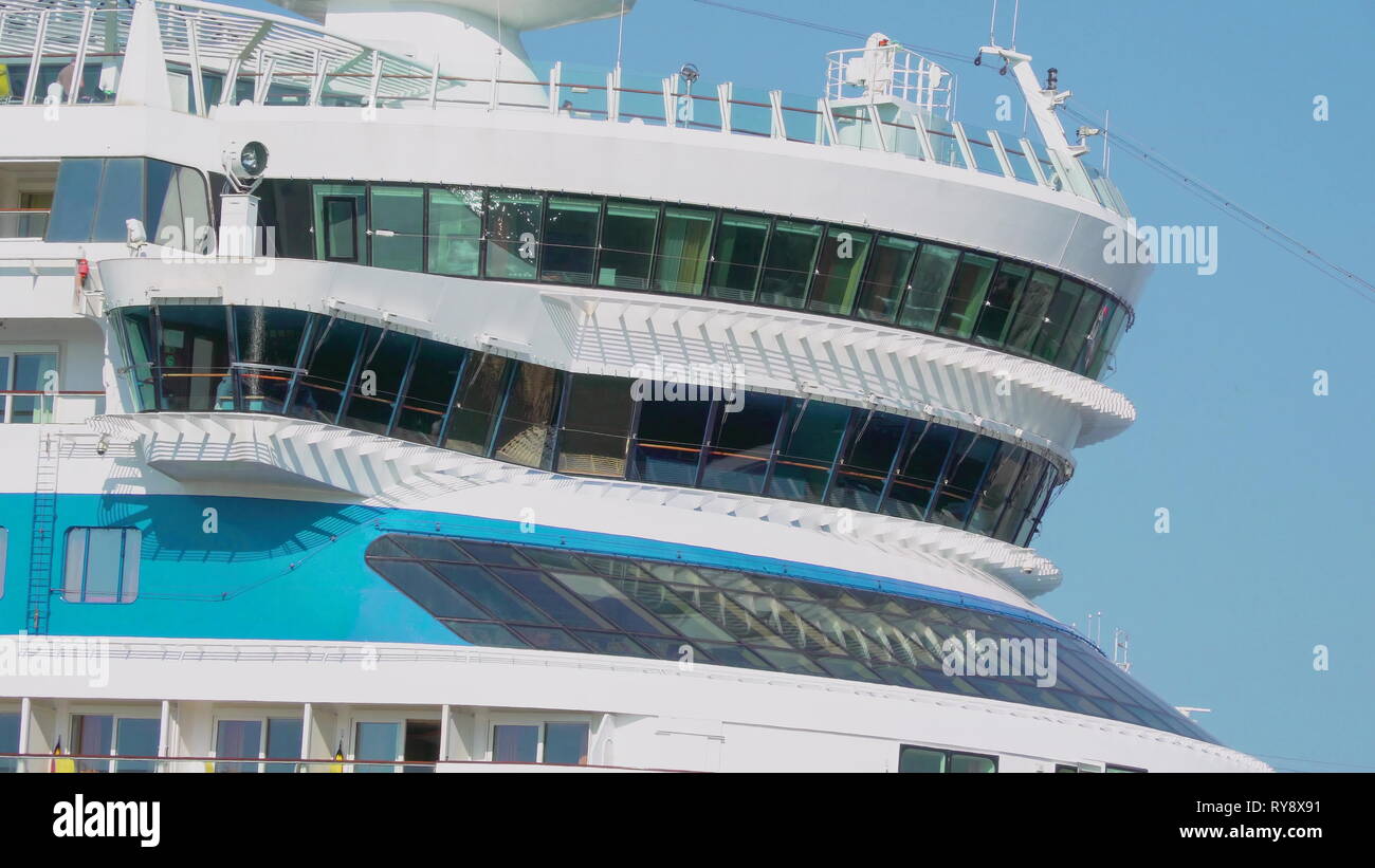 Small glass windows of the big white cruise ship docking on the port in ...