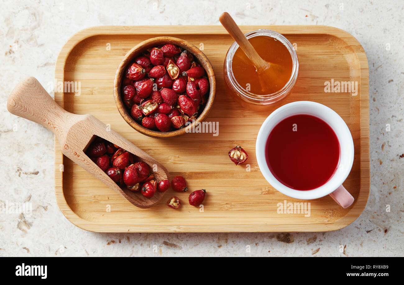 Top view of delicious rose hip tea in cup with dried rose hips on ...