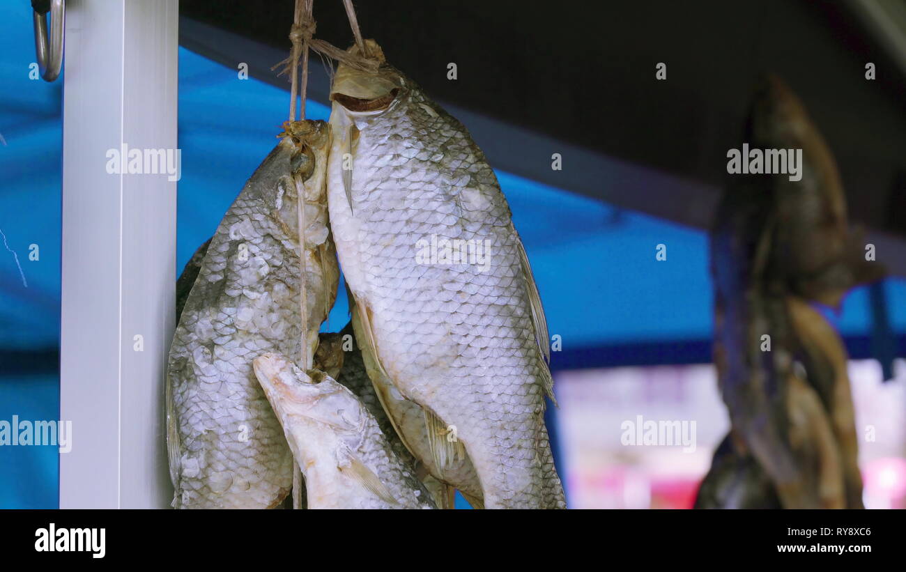 Salted dried fish hanging on the side of the stand and stall in the ...