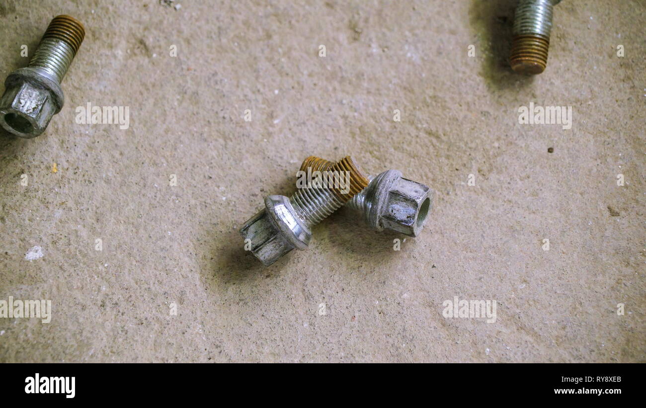Some of the screws on the floor of the auto shop to be used to repair ...
