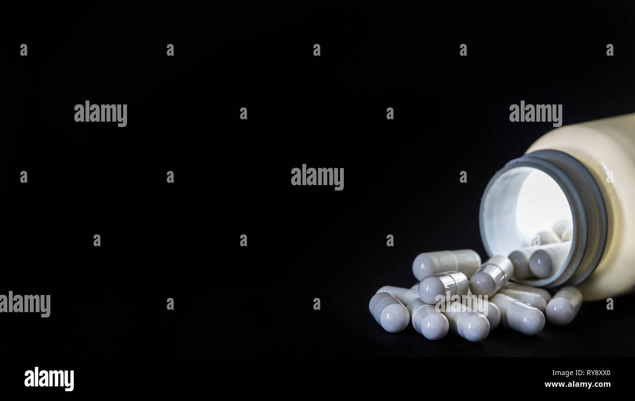 A can of magic pills. A white jar that glows with pills spilled on ...