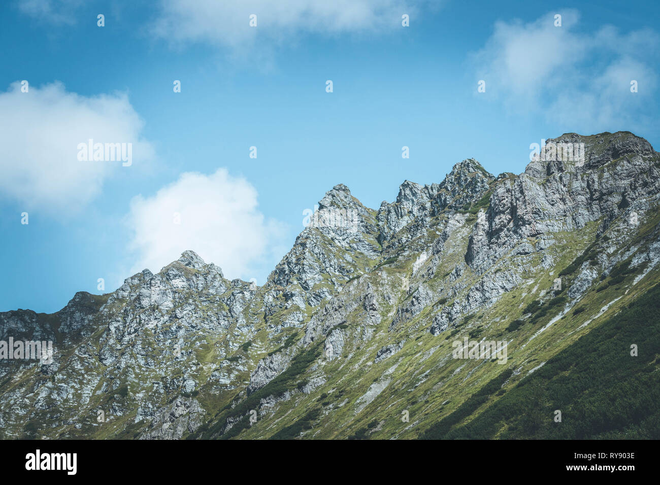 Picture of rugged mountains in the alps, blue sky with clouds Stock ...