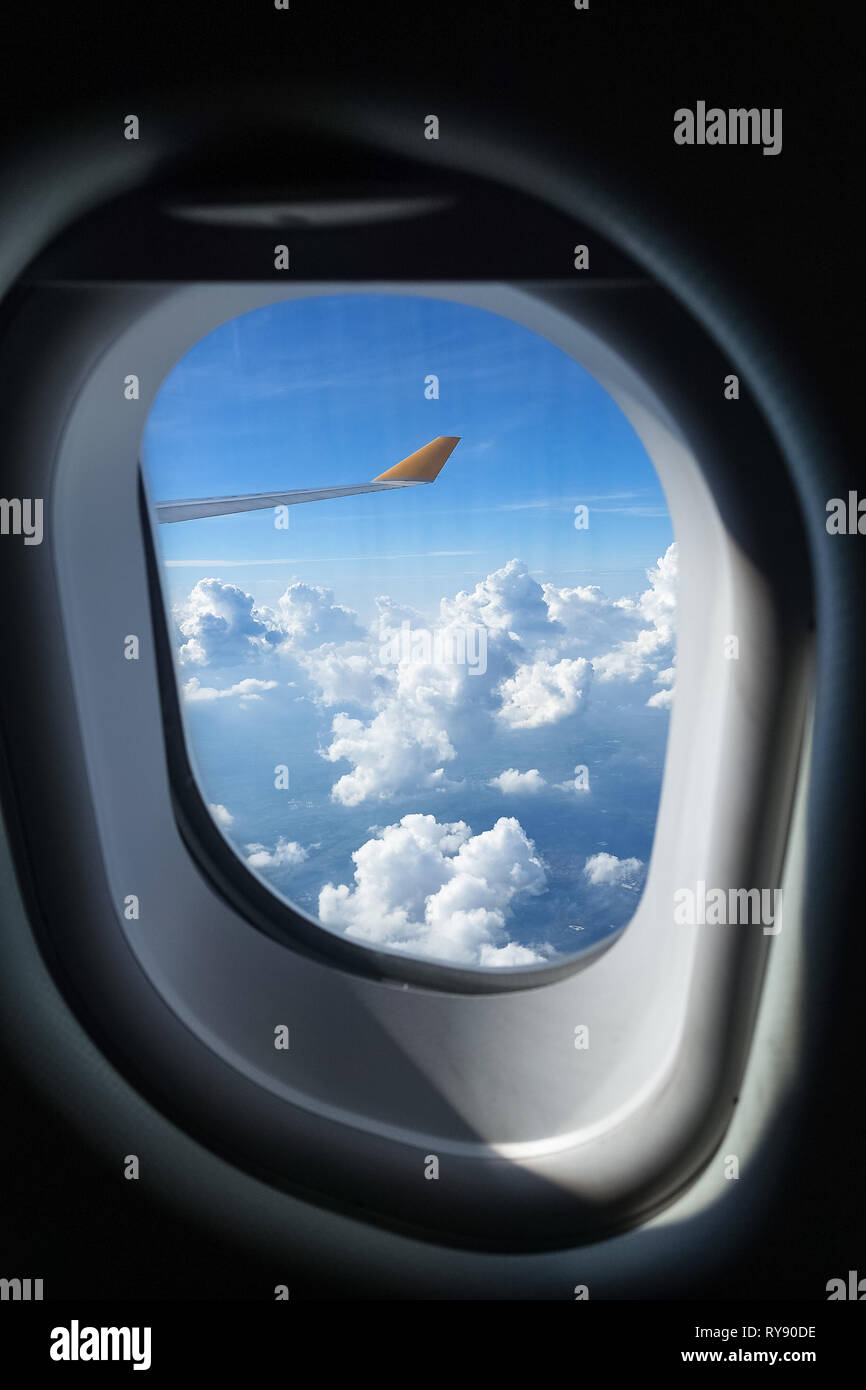 Perfect fluffy clouds out the plane window on sunny, blue sky day Stock ...