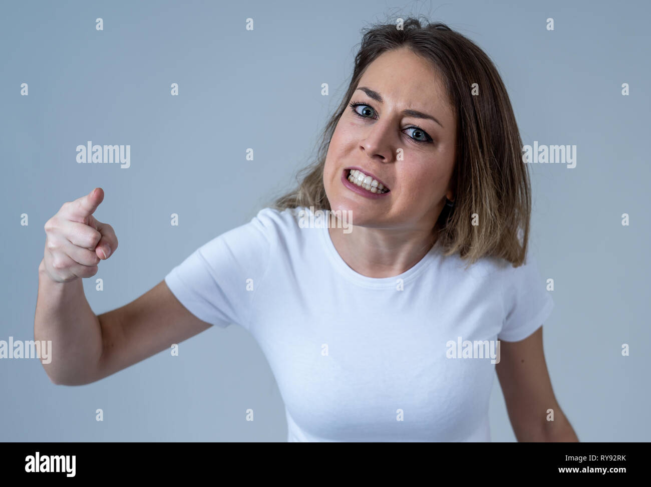 Close up portrait of young attractive caucasian woman with an angry ...