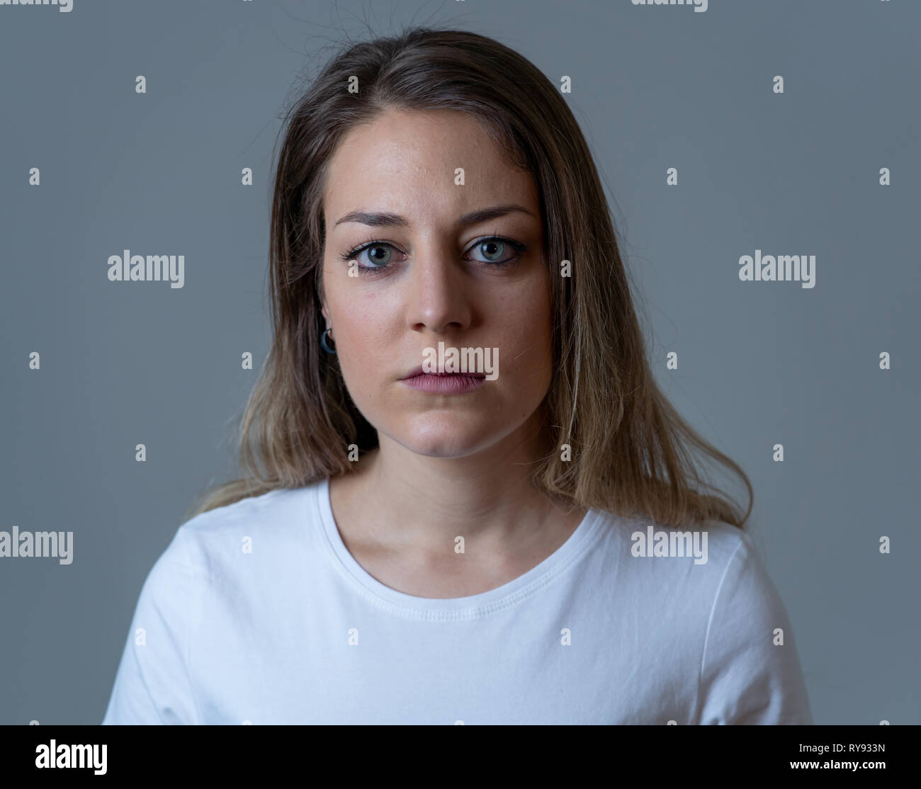 Close up portrait of beautiful young woman with sad mood looking ...