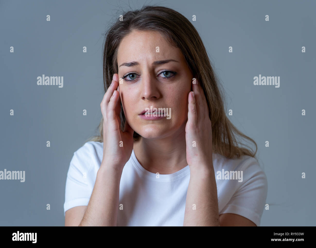 Close up portrait of beautiful young woman with sad mood looking ...