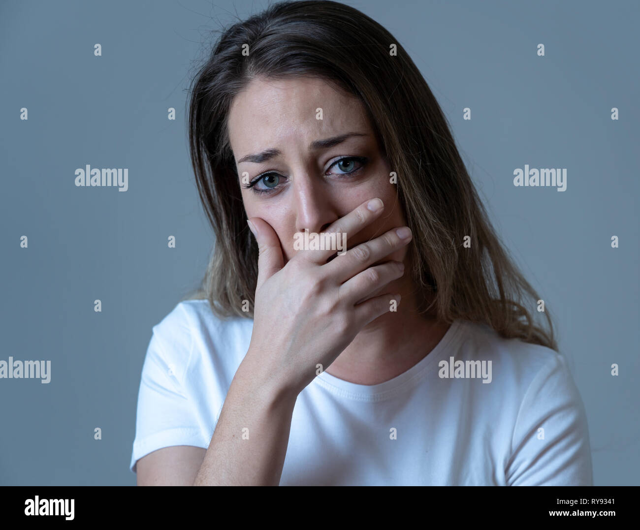 Close up portrait of beautiful young woman with sad mood looking ...