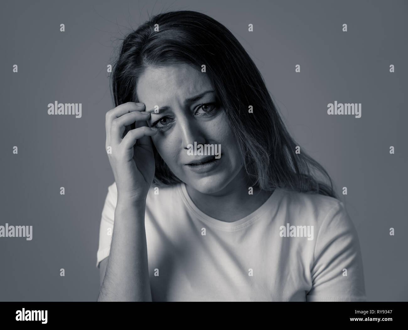 Close up portrait of beautiful young woman with sad mood looking ...