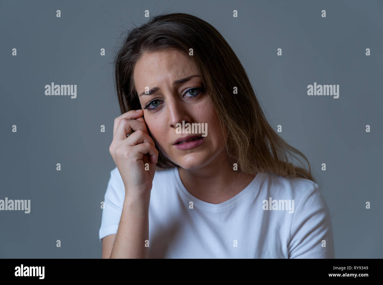 Close up portrait of beautiful young woman with sad mood looking ...