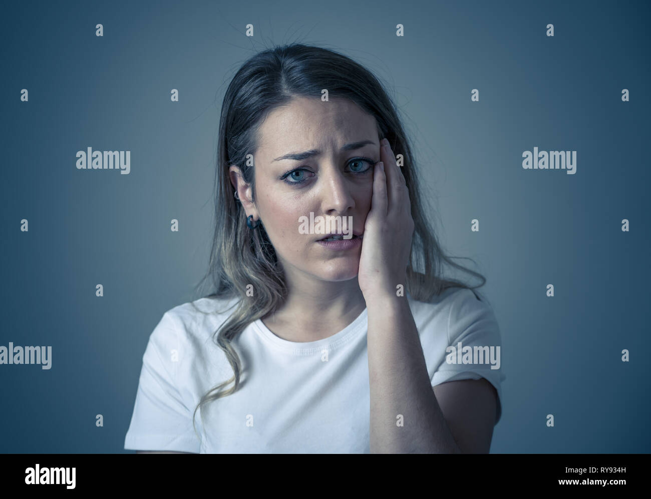 Close up portrait of beautiful young woman with sad mood looking ...