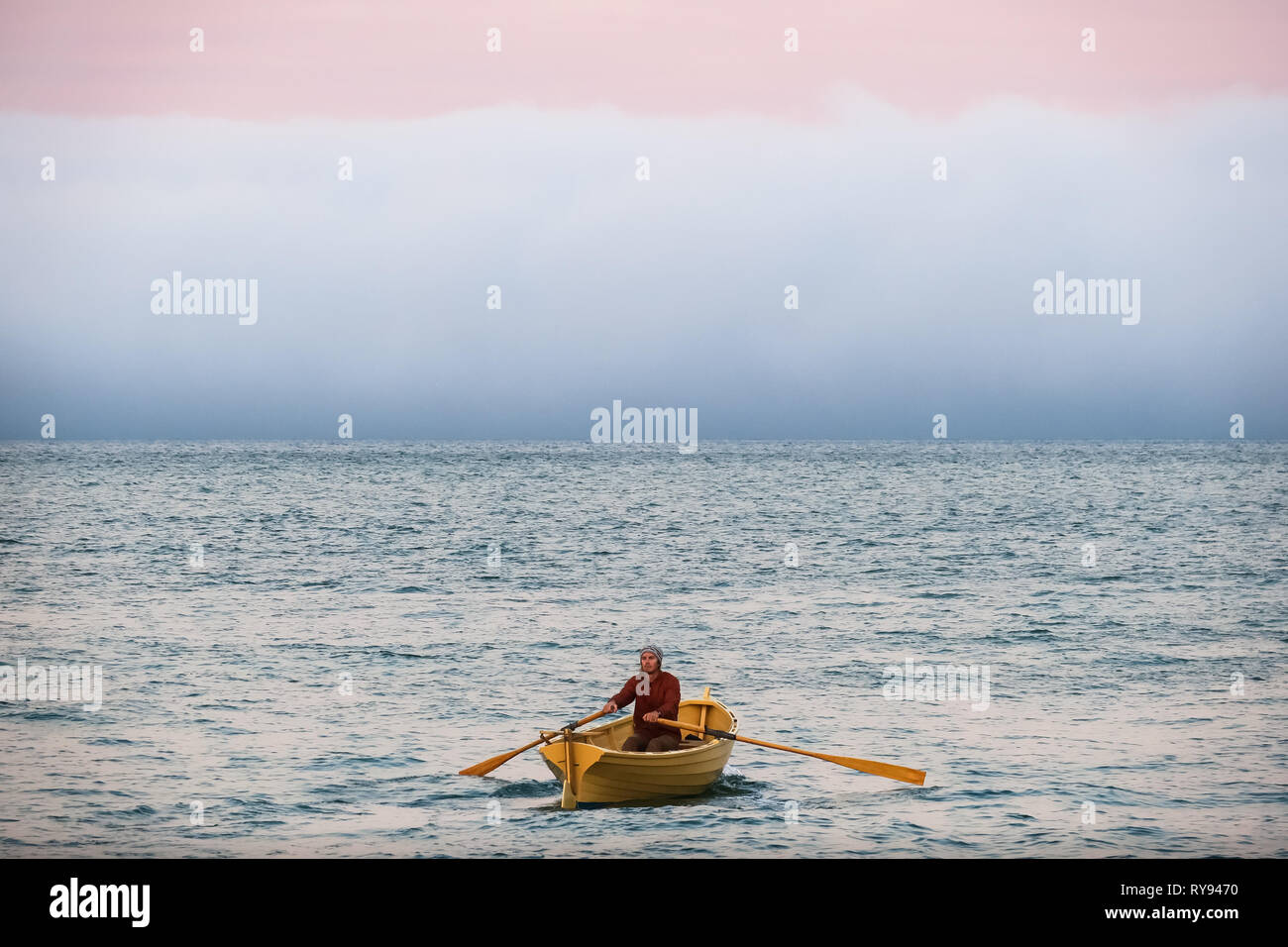 Old man rowing boat hi-res stock photography and images - Alamy