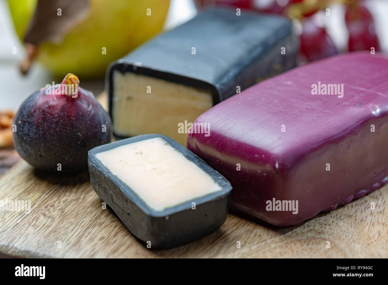 Mini black and dark red waxed cheddar cheeses made from West Country ...