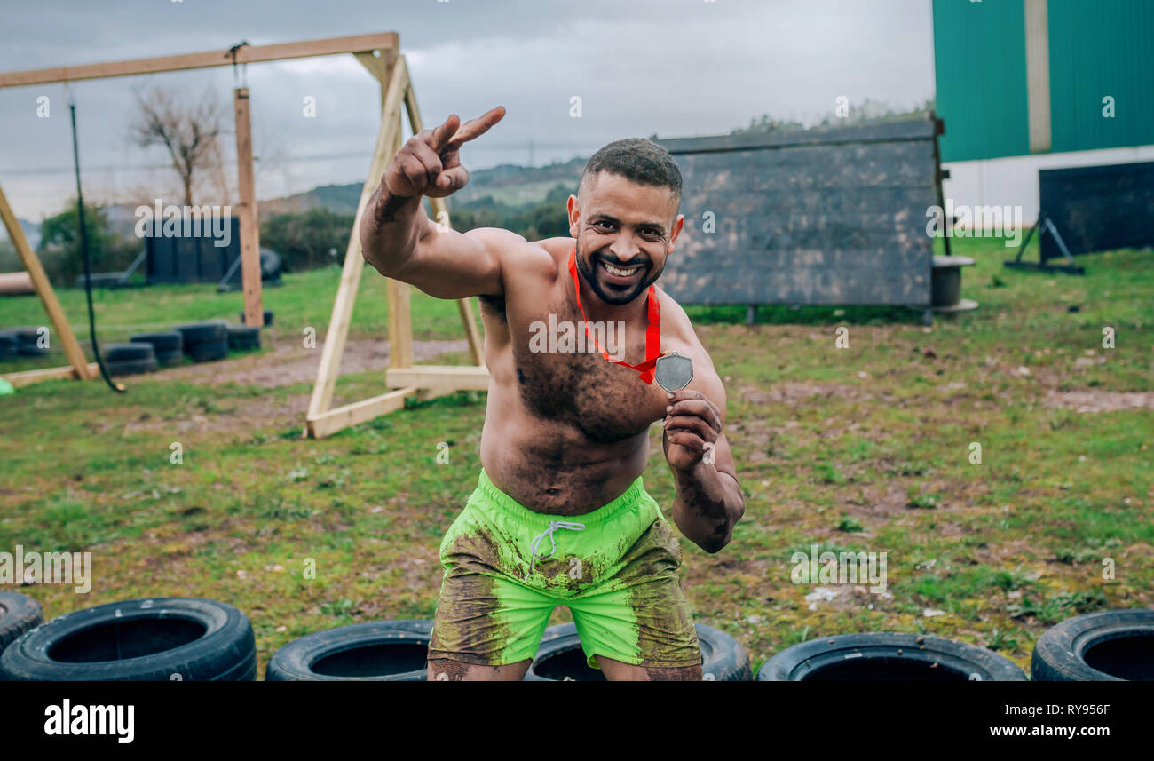 Athlete showing medal after race Stock Photo - Alamy