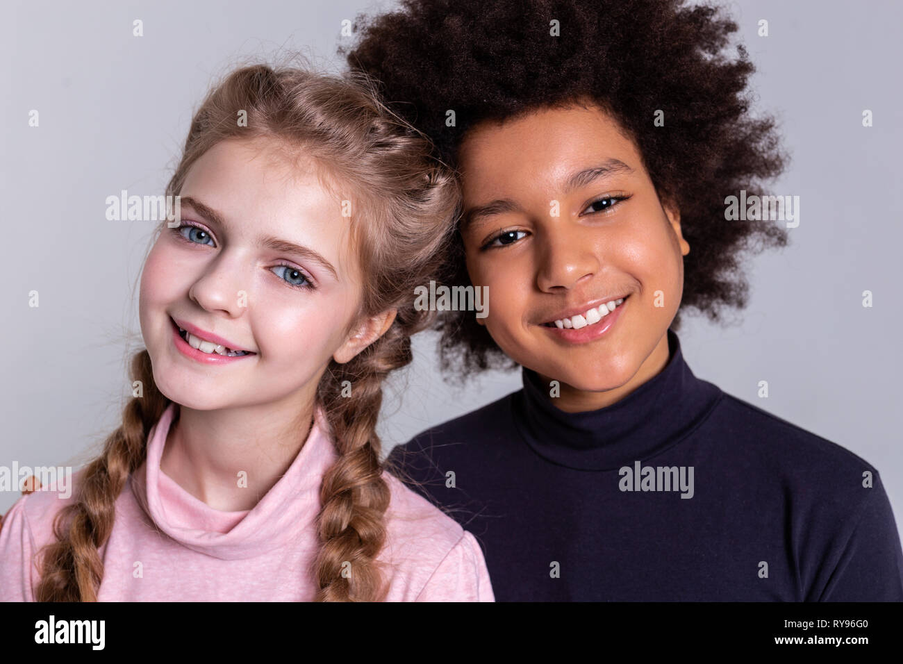 Appealing pretty children standing together and hugging Stock Photo - Alamy