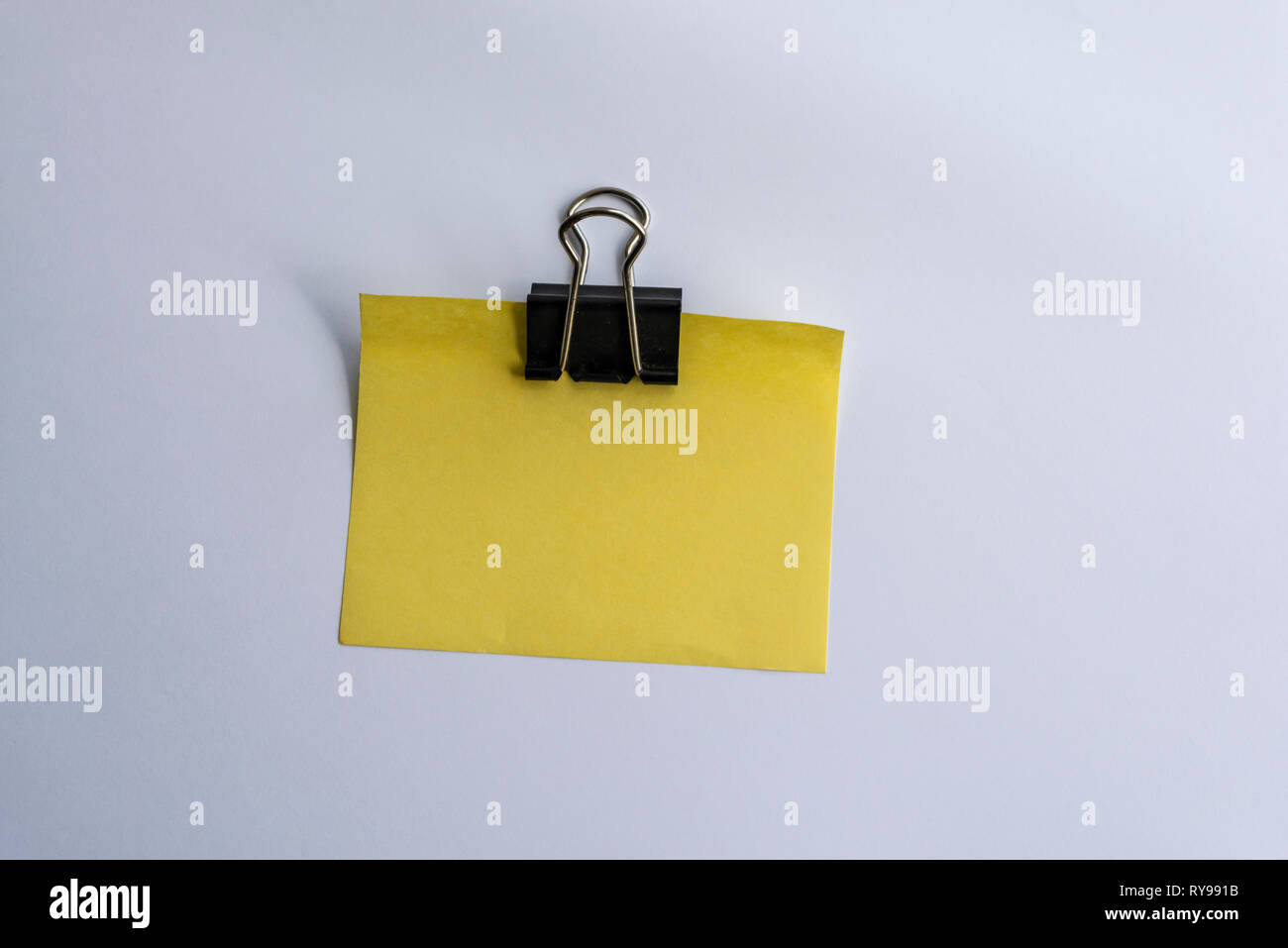 Clipped yellow note Stock Photo - Alamy