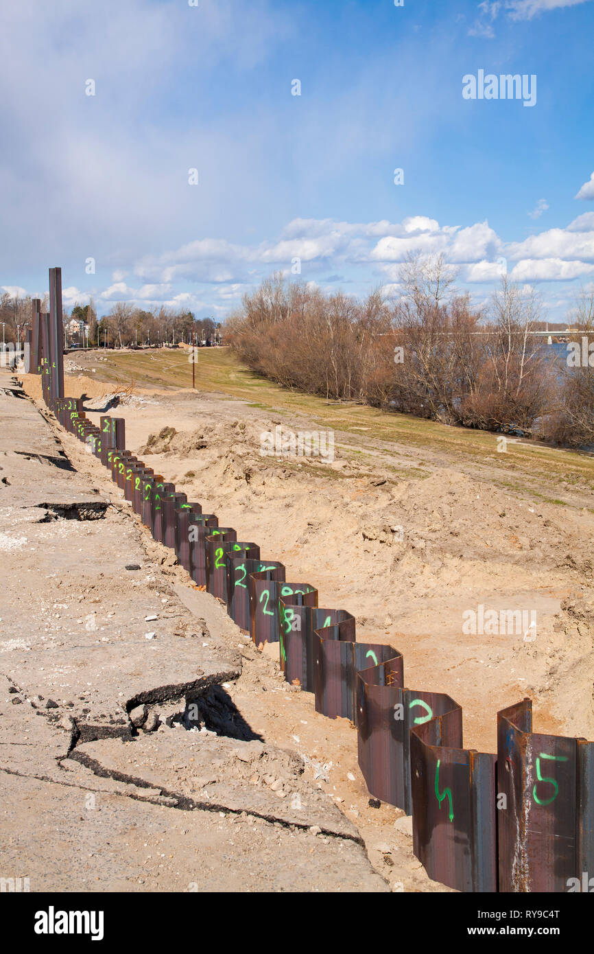Row of steel pillar hitting in the ground to stabilizes the flood ...