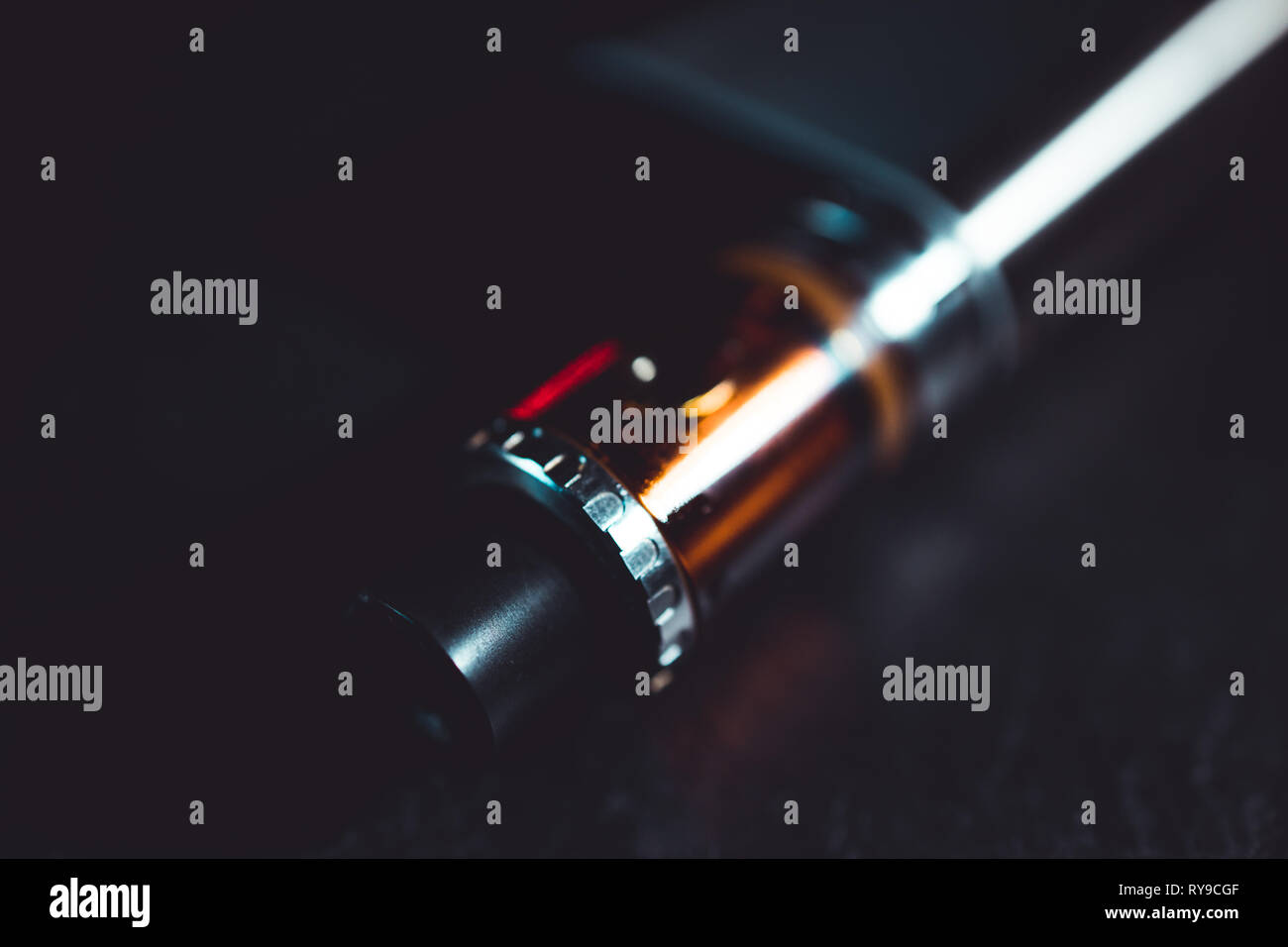 Vape pen metal electronic cigarette with vaping dark background Stock ...