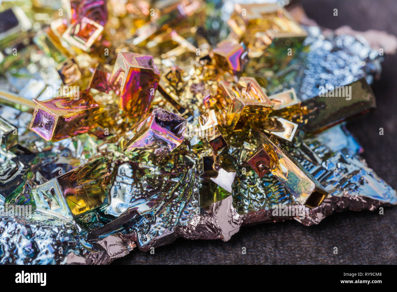 Crystal of bismuth on dark stone background Stock Photo - Alamy
