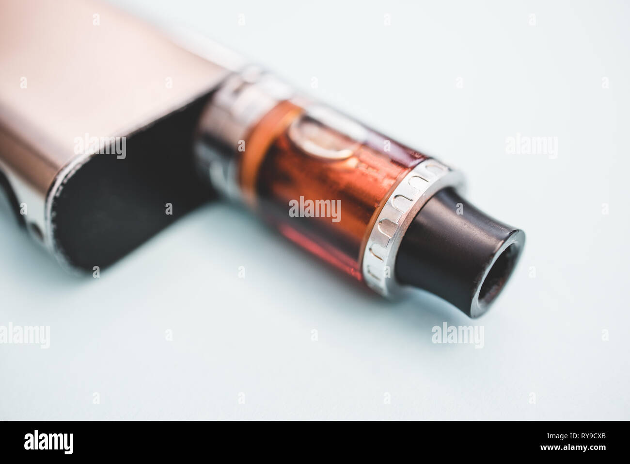 Vape pen metal electronic cigarette with vaping blue background Stock ...