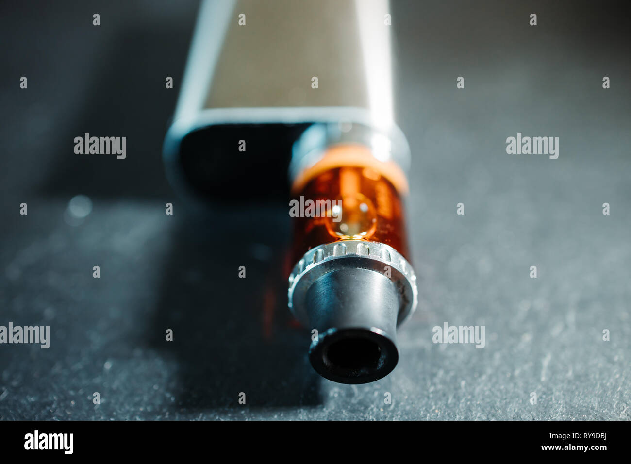 Vape pen metal electronic cigarette with vaping dark background Stock ...