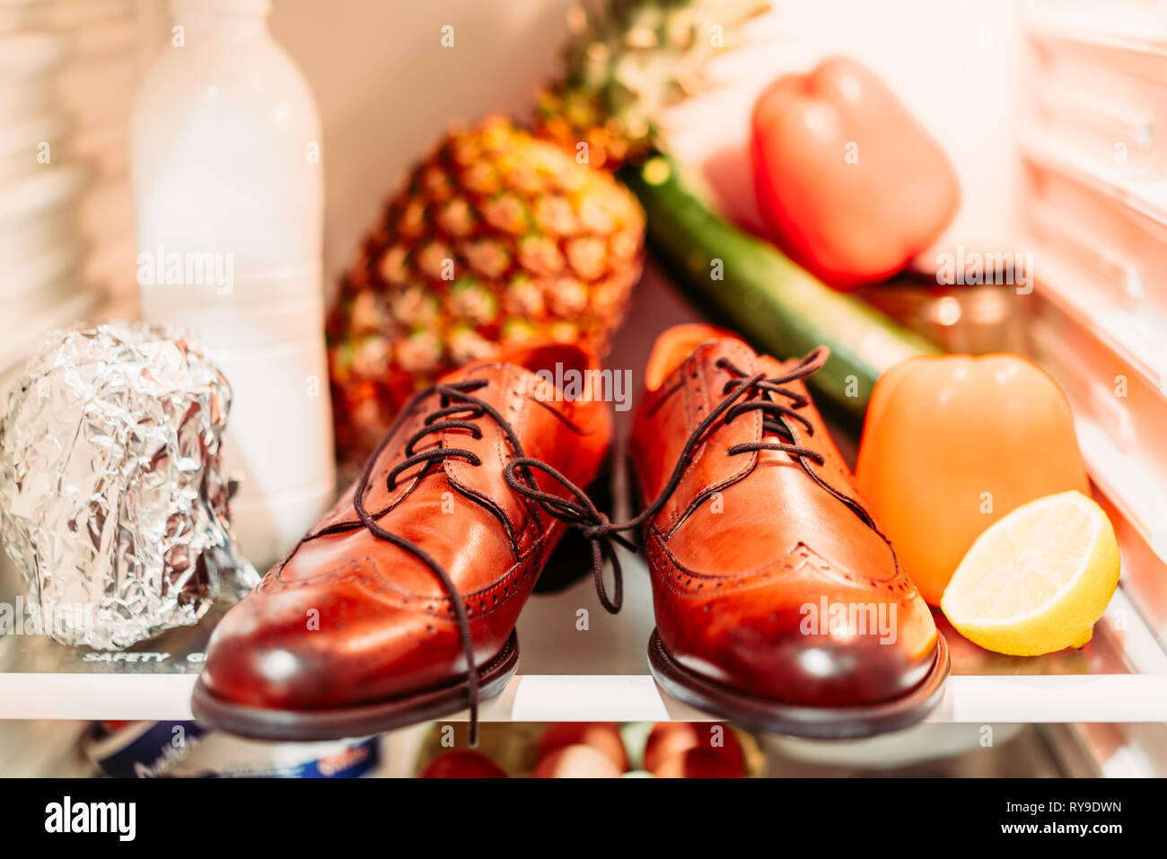 Shoes and food into a refrigerator for fools day Stock Photo - Alamy