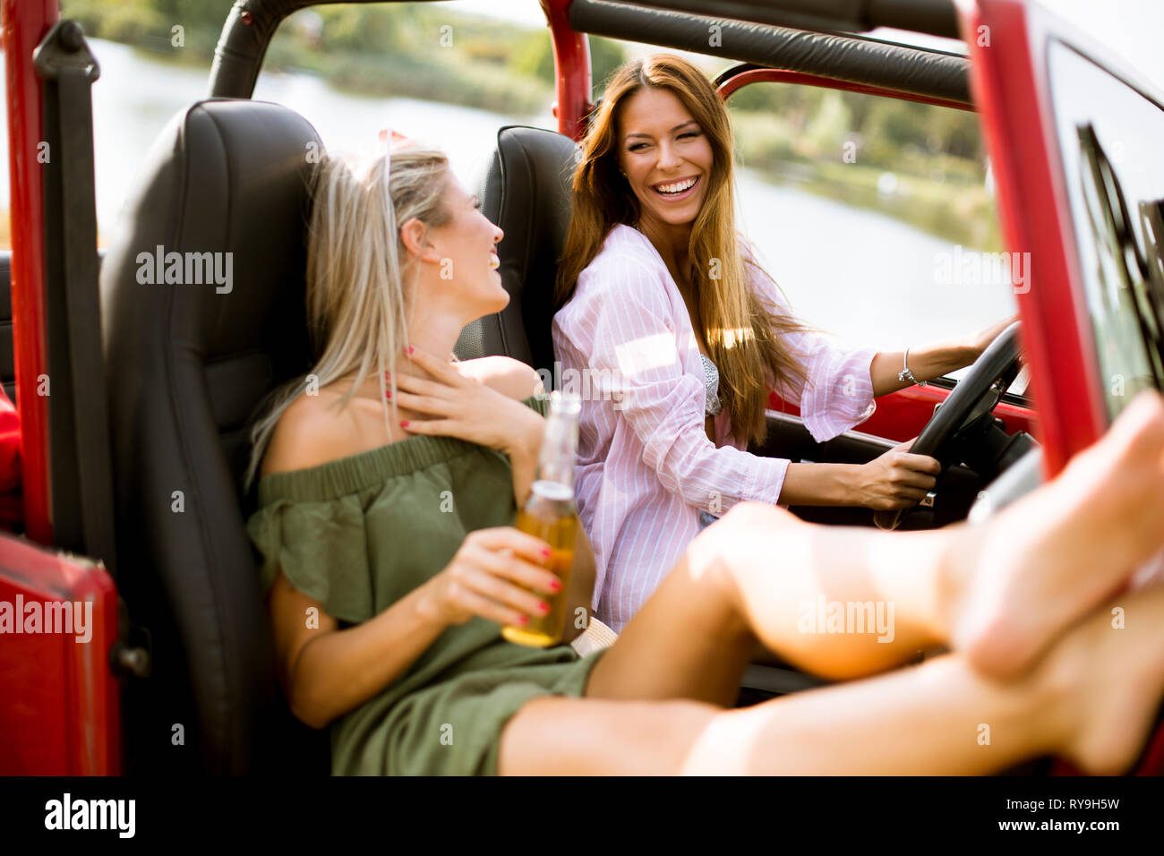 Attractive young women having fun in a convertible car Stock Photo - Alamy