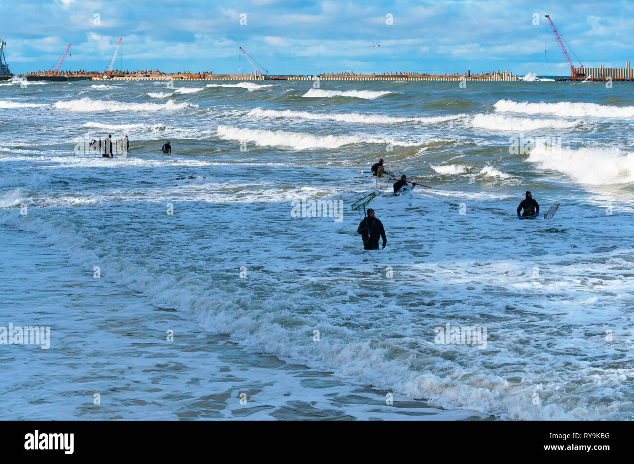 fishing for amber, people catch amber waves, the Baltic sea ...