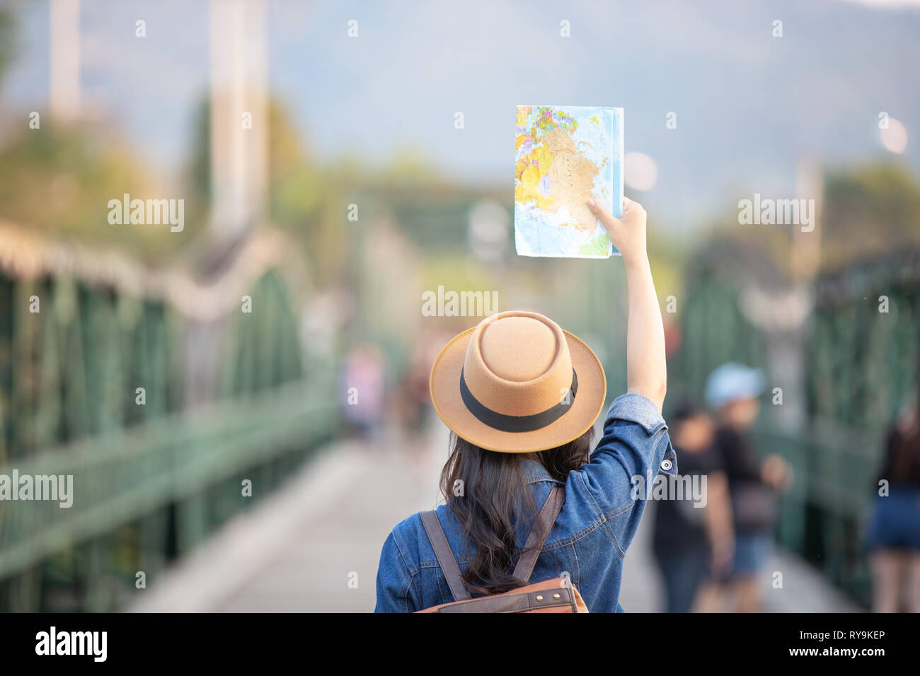 Female tourists on hand have a happy travel map Stock Photo - Alamy