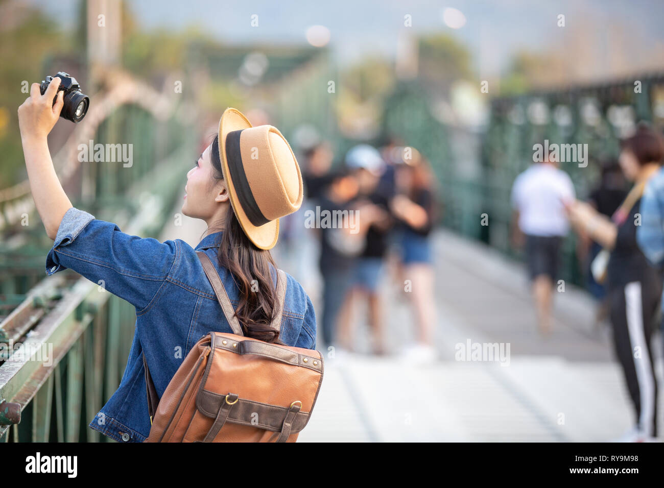 Female tourists who are taking photos of the atmosphere and smile ...