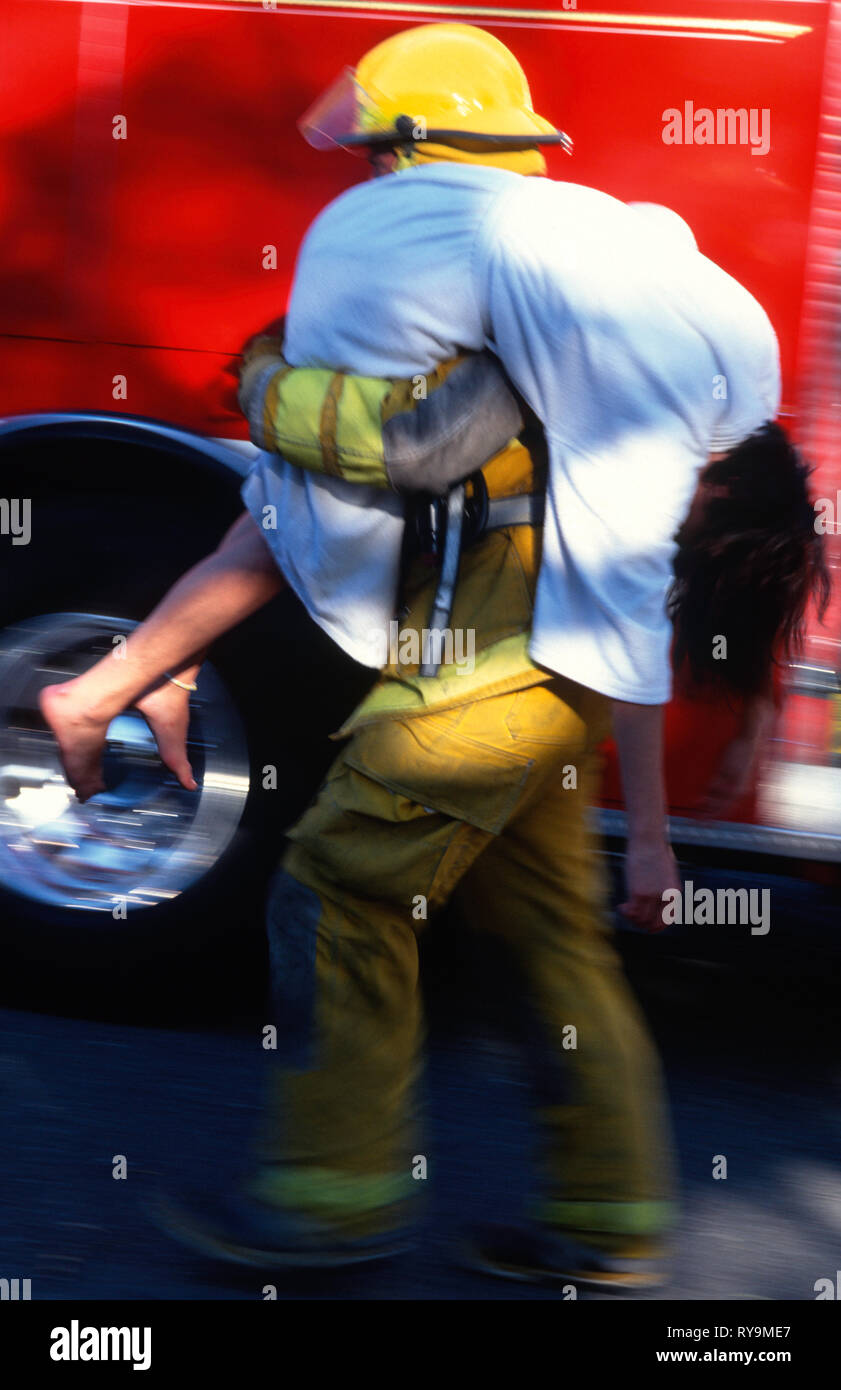Fireman Rescuing a Young Girl at a Fire Scene, USA 1997 Stock Photo - Alamy