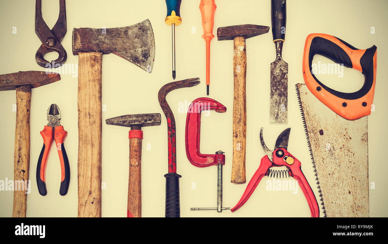 Set of vintage hand construction tools on a white wooden background ...