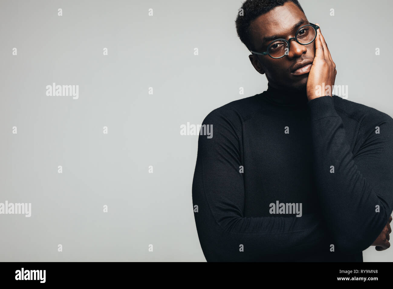 Young black man thinking hi-res stock photography and images - Alamy