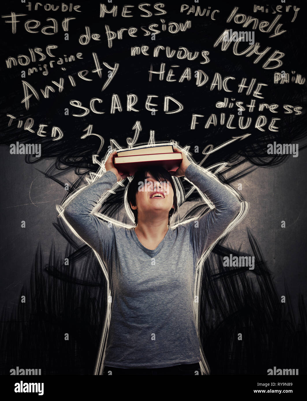 Woman looking up scared, covering head with books. Desperate girl ...