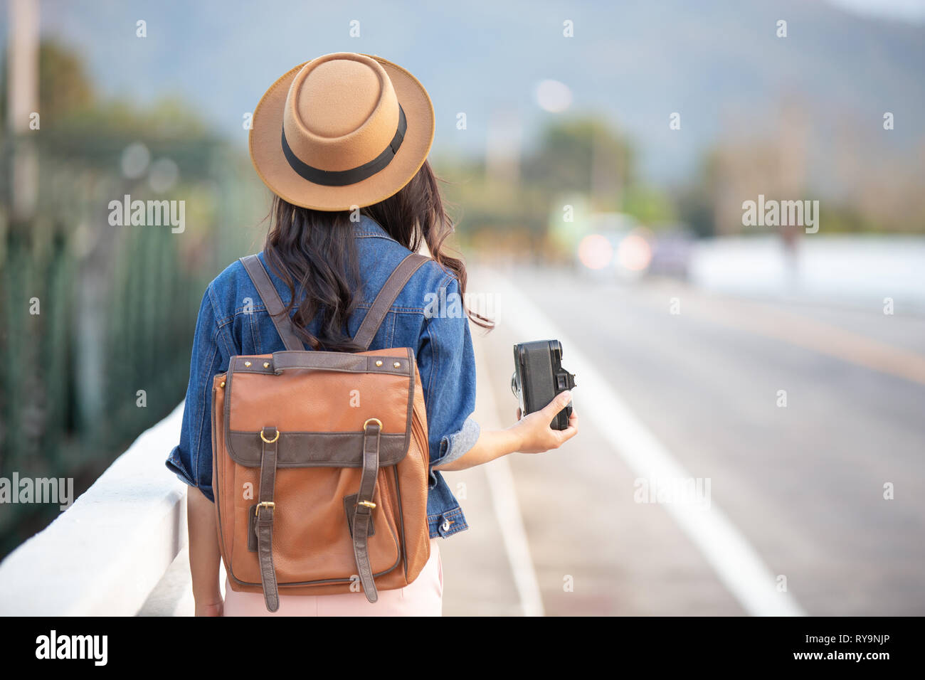 Female tourists who are taking photos of the atmosphere and smile ...