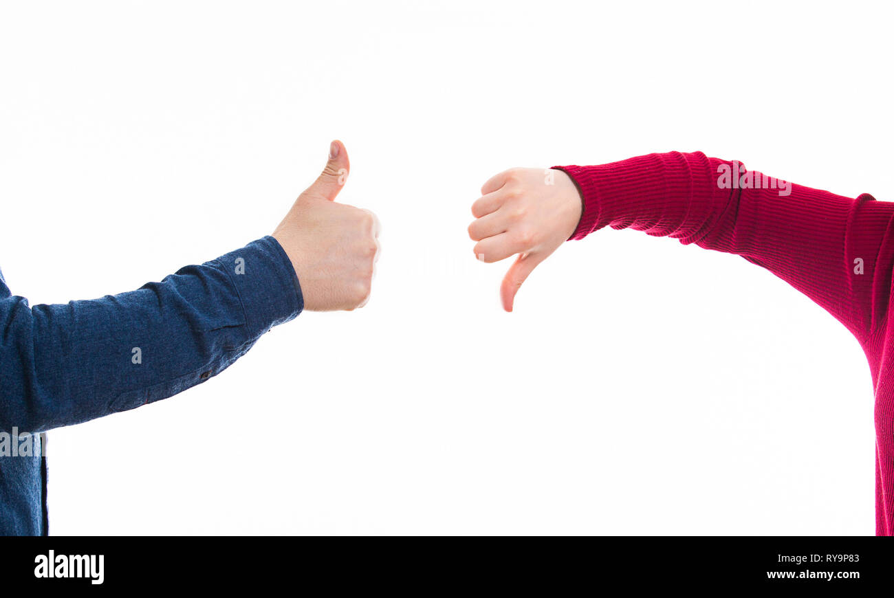 Close up of man and woman hands giving thumbs up and down, positive vs ...