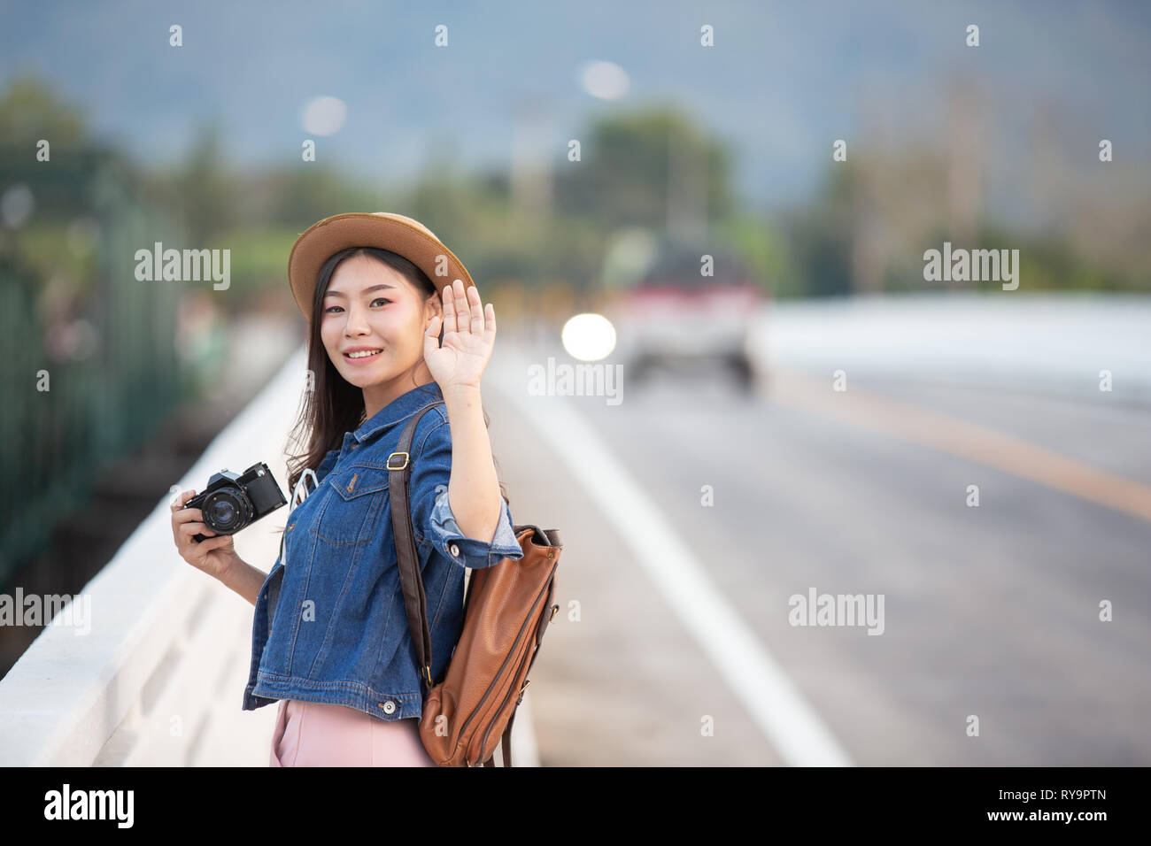 Female tourists who are taking photos of the atmosphere and smile ...